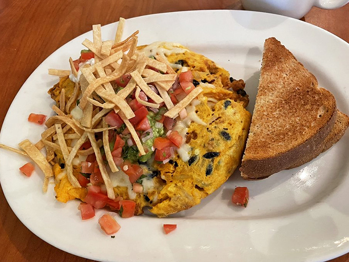 This isn't just an omelet—it's a colorful fiesta wrapped in eggs, topped with crispy tortilla strips that add the perfect crunch factor.