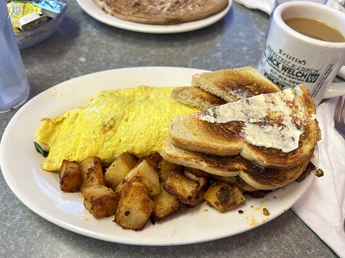 Yellow breakfast geometry&mdash;a perfect omelet curves alongside golden home fries and buttery toast, creating the breakfast equivalent of winning the lottery.