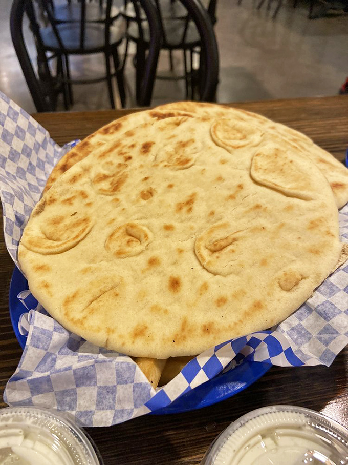 The unsung hero of any gyro experience: freshly baked pita bread with those beautiful char marks that promise a perfect chew.
