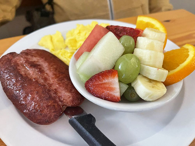 A plate that balances indulgence and virtue &ndash; hearty Polish sausage alongside a rainbow of fresh fruit that makes your doctor slightly less worried.