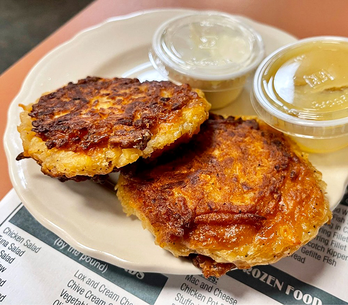 Golden potato pancakes with crispy edges and tender centers, served with the traditional dilemma: applesauce or sour cream? (The answer: both.)