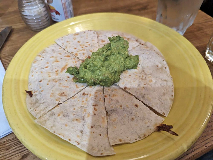 Simplicity at its finest: a quesadilla with guacamole hat, ready to prove that the best things in life don't need to be complicated.