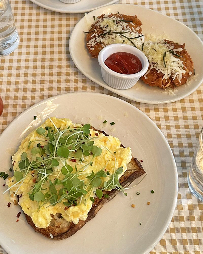 Scrambled eggs that look like clouds on toast, garnished with microgreens that add both color and the illusion of healthfulness.