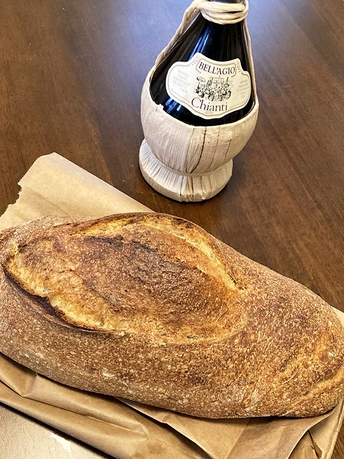 This rustic loaf posing with Chianti isn't just bread&mdash;it's the beginning of an Italian love story waiting to happen.