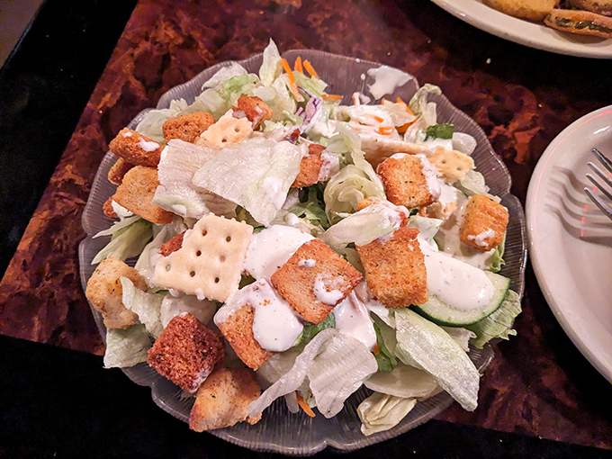A salad that doesn't apologize for being a salad. Those croutons and fresh vegetables are having their own little party on the plate.