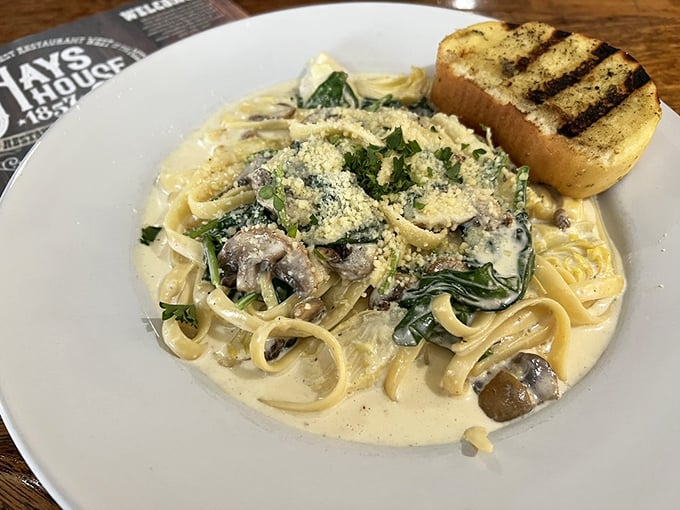 Pasta that proves the Midwest understands comfort: creamy spinach and mushroom fettuccine that would make an Italian grandmother nod in respectful approval.