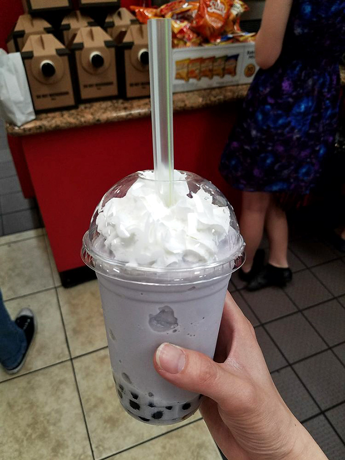 The taro bubble tea stands tall and proud, a purple-hued refreshment that's both drink and entertainment in one convenient cup.