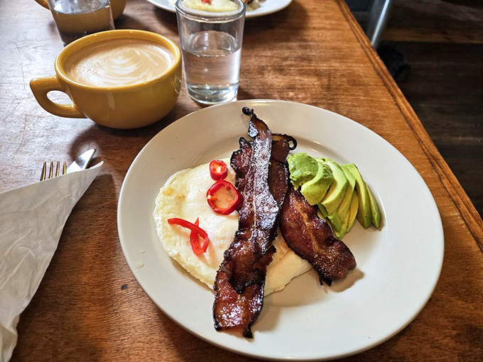 Thick-cut bacon that's been given the respect it deserves, alongside perfectly cooked eggs. The avocado is just showing off at this point.