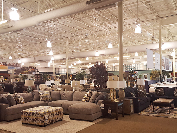 The showroom stretches into infinity, a furniture wonderland where sectionals and accent chairs live in perfect harmony. Decision paralysis has never felt so comfortable.