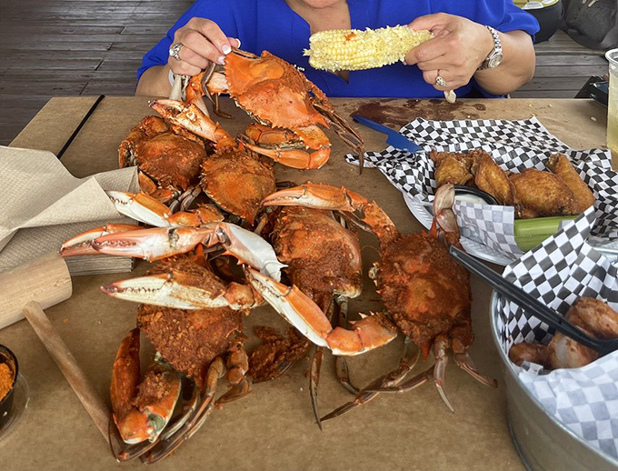 The ultimate Maryland experience: steamed crabs dusted with Old Bay, spread across brown paper. Prepare to get deliciously messy!