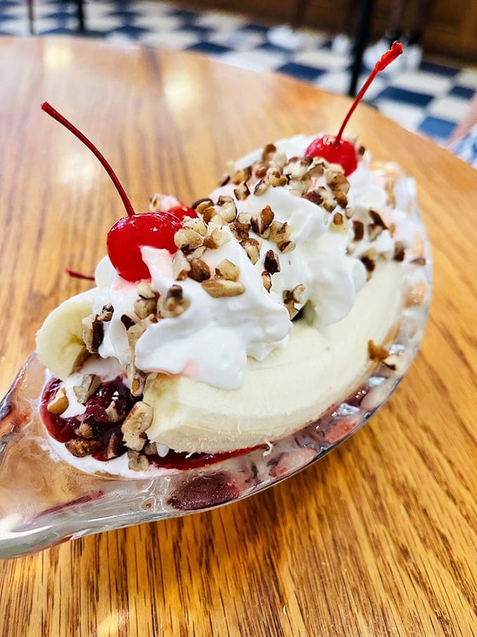 The banana split&mdash;America's dessert diplomat&mdash;bringing together fruit, ice cream, and toppings in perfect harmony on a wooden table.