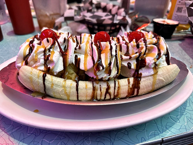The banana split defies gravity and moderation, a yellow canoe sailing through rivers of chocolate and whipped cream toward your happy place.