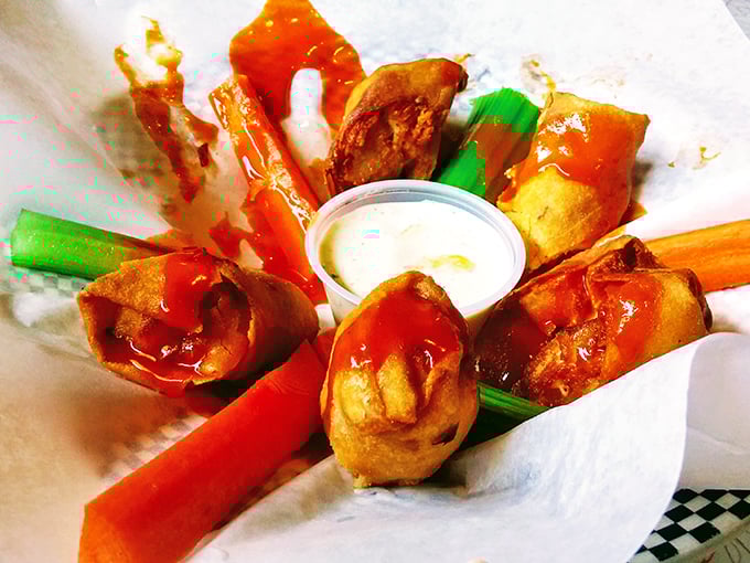 Buffalo chicken egg rolls—where East meets West meets rock and roll. Crispy outside, spicy inside, with cool ranch for balance.