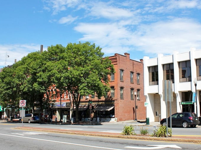 Sun-drenched brick buildings house apartments above street-level shops, creating a walkable downtown where everything you need is nearby.
