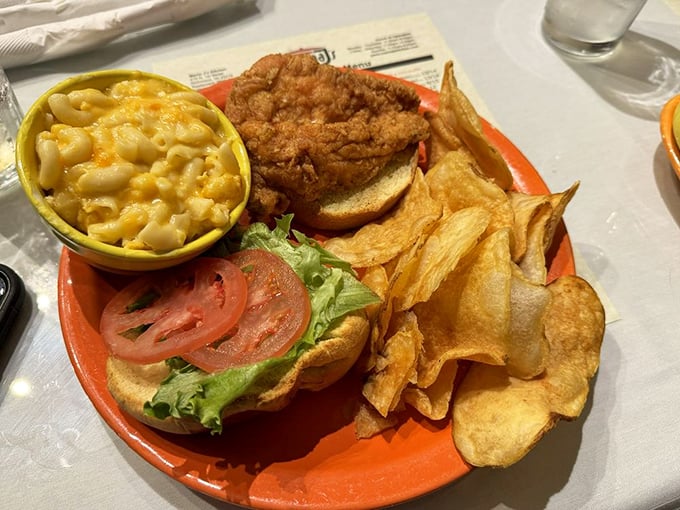 A sandwich that demands two hands and your full attention, flanked by mac and cheese that's having its own moment.