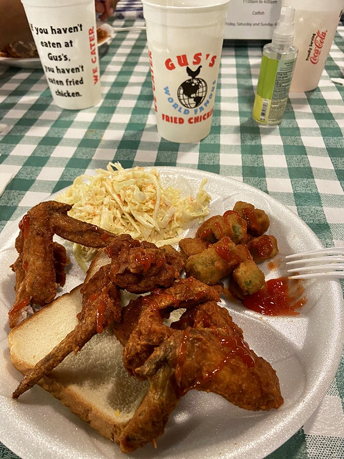 A plate that makes you wonder if you should've ordered double. Hot sauce and white bread: the supporting actors in this chicken drama.
