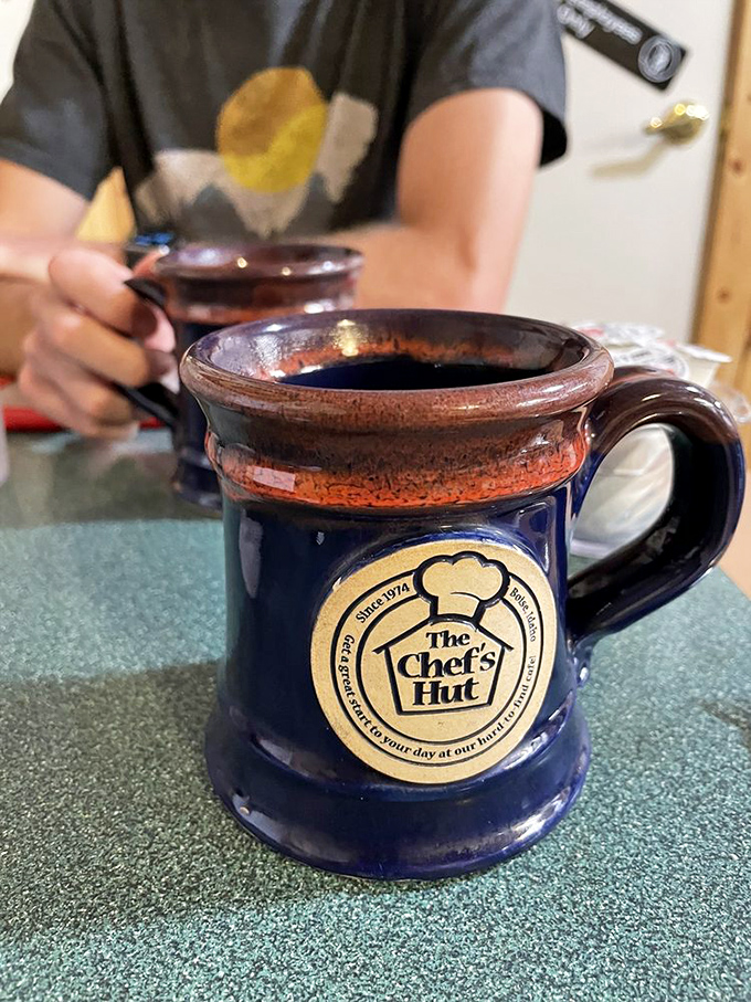 Their signature mug doesn't just hold coffee&mdash;it holds the essence of morning itself. Navy blue ceramic with the Chef's Hut logo: a silent promise of consistent comfort.