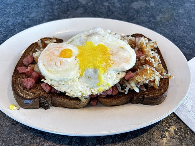 Breakfast engineering at its finest. Hash browns, egg, and corned beef on toast&mdash;proof that sometimes the simplest combinations are culinary genius.