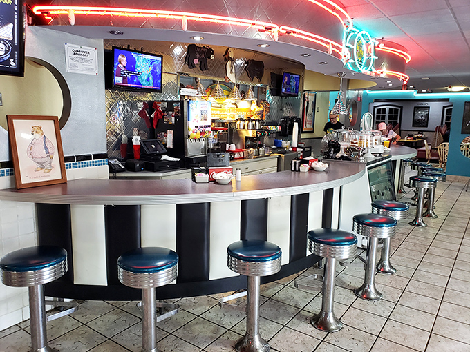 The counter where breakfast dreams come true, complete with classic chrome stools that have supported countless elbows and morning conversations.
