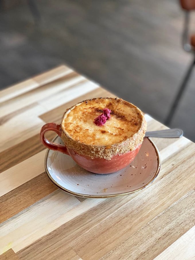 That cr&egrave;me br&ucirc;l&eacute;e latte isn't just coffee; it's dessert in disguise wearing a deceptively sensible pink ceramic disguise.