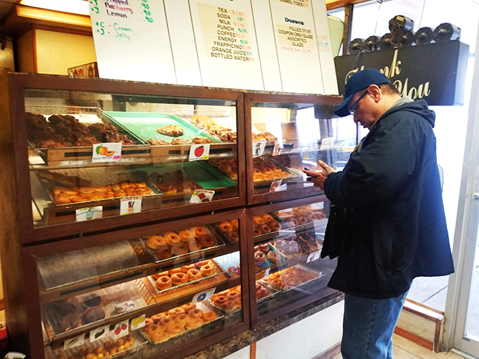 The moment of decision &ndash; a customer contemplates life's most important question: which donut deserves to come home today?