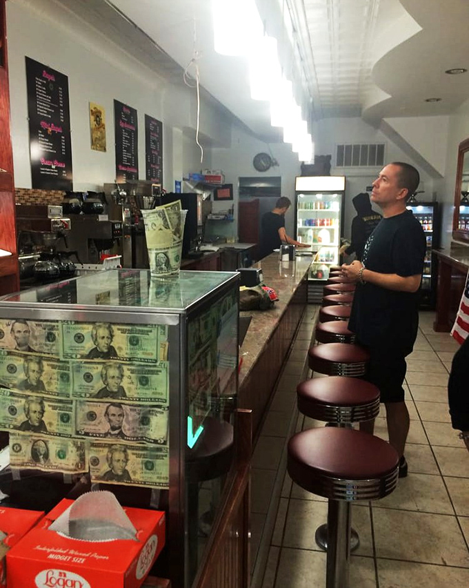 At the counter, where patient customers contemplate life's most important question: which donut deserves to come home with them today?