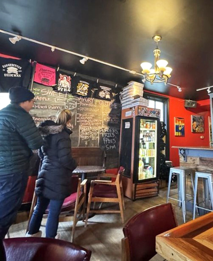 Customers contemplating their pie destiny at the chalkboard menu. Life's big decisions should always involve this much joy.