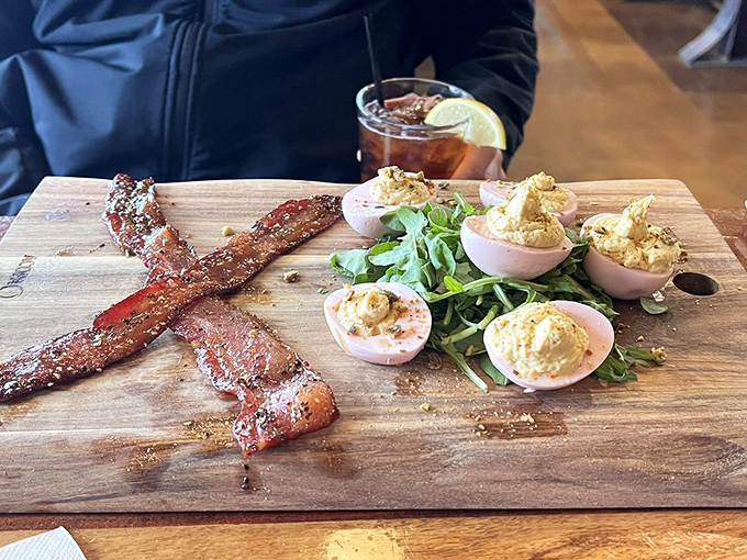 Deviled eggs and bacon strips sitting pretty on a wooden board&mdash;proof that sometimes the simplest appetizers provide the most profound happiness.