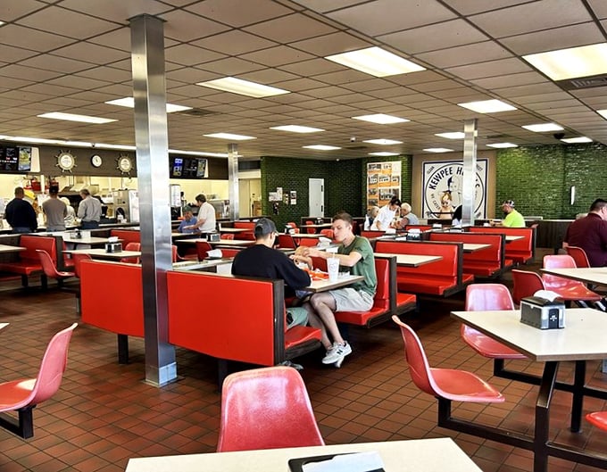 The modern diner experience: strangers united by the universal language of "that first bite of a really good burger" spoken fluently across every booth.