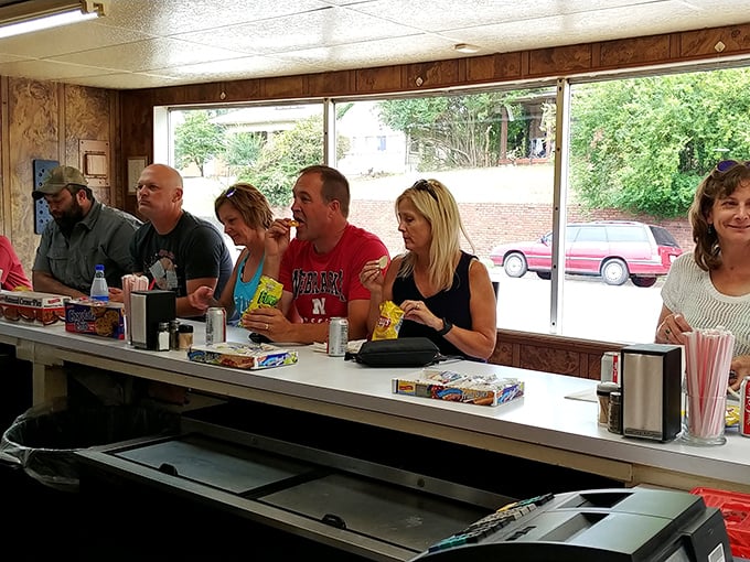 The counter fills with hungry patrons clutching bags of chips, united in the universal language of "waiting for something wonderful."