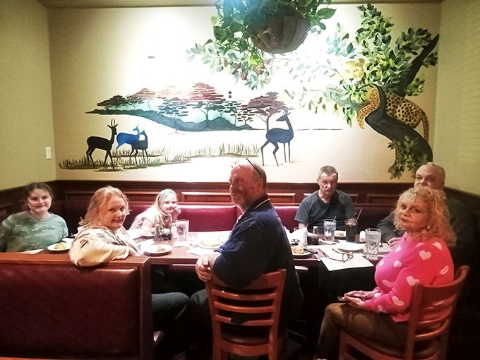 The mural brings the safari theme home without going full "theme park." Nothing enhances digestion like dining under the watchful eyes of savanna wildlife.