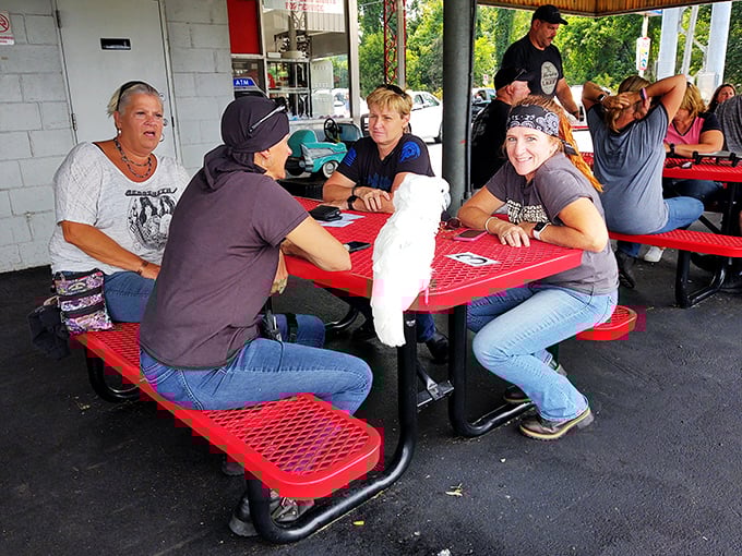 The outdoor picnic area where strangers become friends over shared appreciation of perfectly grilled beef. Some therapists call this "burger bonding."