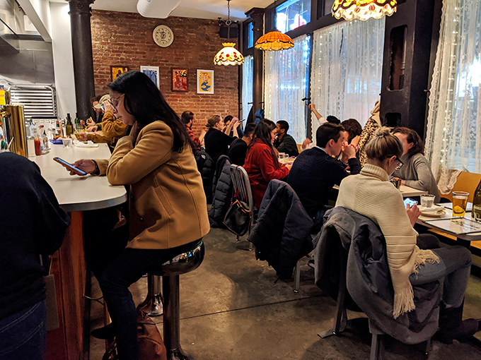 Weekend brunch warriors in their natural habitat, hunting for the perfect bite while armed with nothing but forks and enthusiasm.