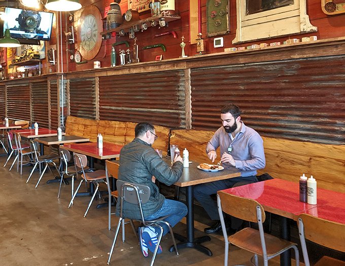 Two diners experiencing what philosophers call "chicken nirvana"&mdash;that moment when conversation pauses because the food demands full attention.