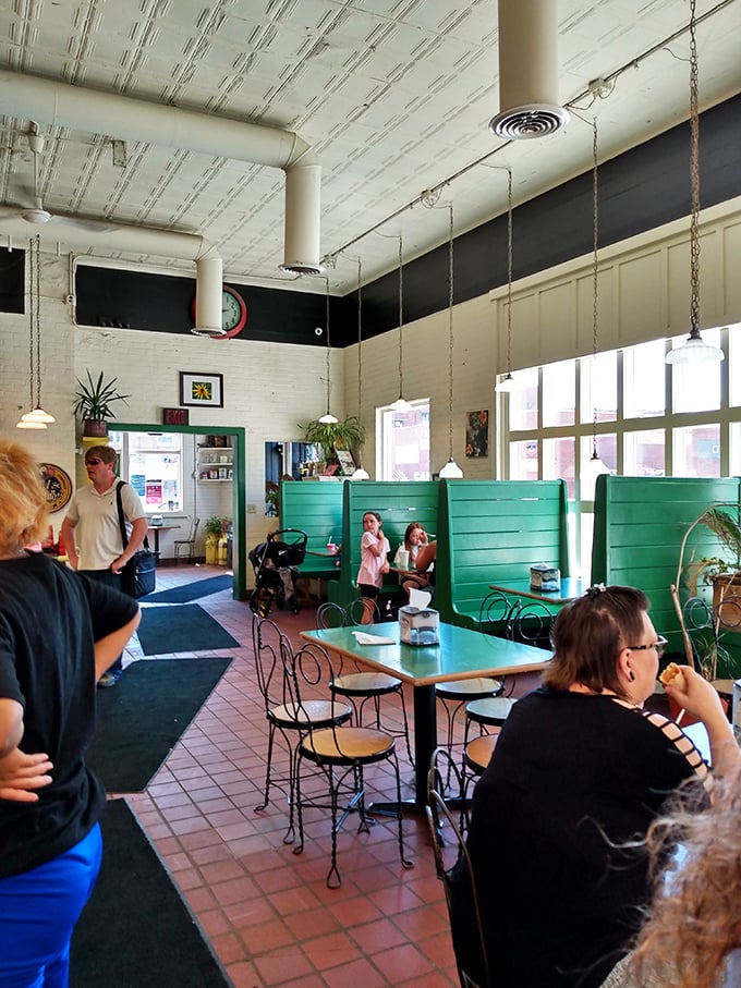 Where ice cream dreams come true &ndash; patrons enjoying their frozen treasures in a space that balances retro charm with modern comfort. 