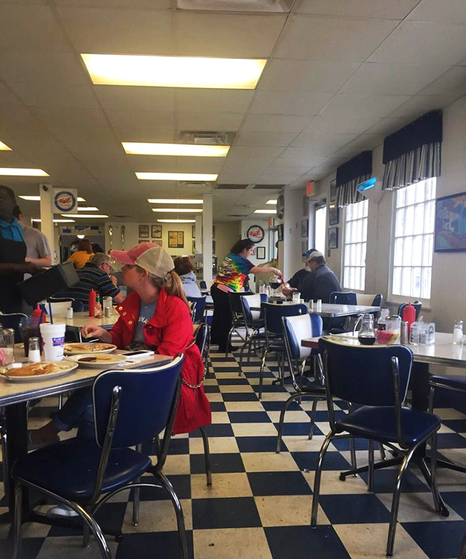 Where strangers become neighbors over plates of comfort food. The busy lunch rush at Blue & White is a masterclass in community gathering.
