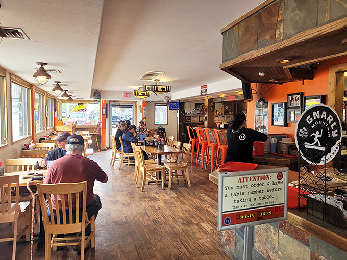 Every table tells a story of barbecue pilgrims finding their happy place. The orange chairs aren't the only bright spots in this room.