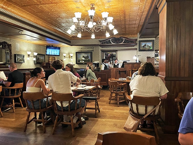 The dining room hums with conversation and clinking glasses &ndash; each table a tiny island of merriment in this British oasis.