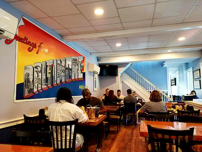 The "Greetings from Baltimore" mural watches over diners engaged in the serious business of seafood enjoyment.
