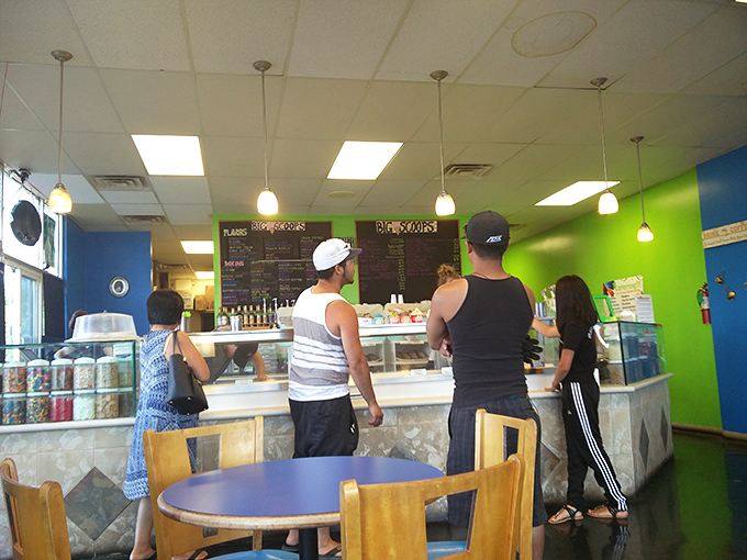 Customers line up at the counter, experiencing that unique mix of anticipation and indecision that comes when facing dozens of ice cream possibilities. 