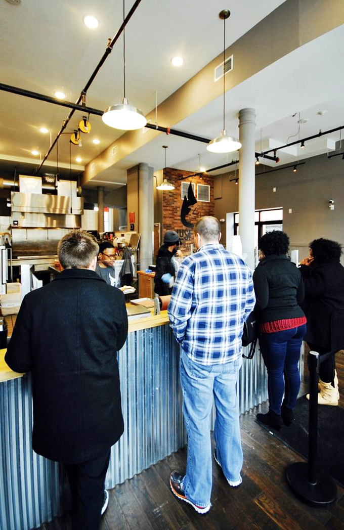 The line forms here for smoky salvation. These patient pilgrims know that good barbecue, like all worthwhile relationships, is worth the wait.