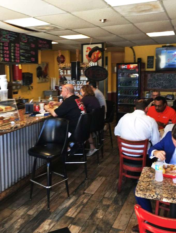 Where chicken enthusiasts gather at the altar of crispiness. Notice how nobody's looking at their phones&mdash;they're too busy experiencing poultry nirvana.