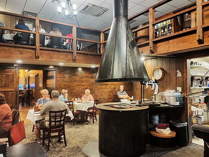 The central fireplace isn't just for show &ndash; it's the beating heart of this dining room where generations have gathered to break bread and share stories.