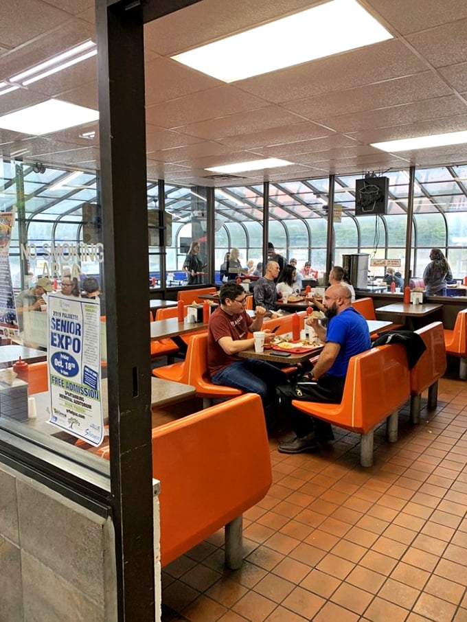 Strangers become neighbors across these orange booths, united by the universal language of "pass the ketchup" and appreciative food mumbles.