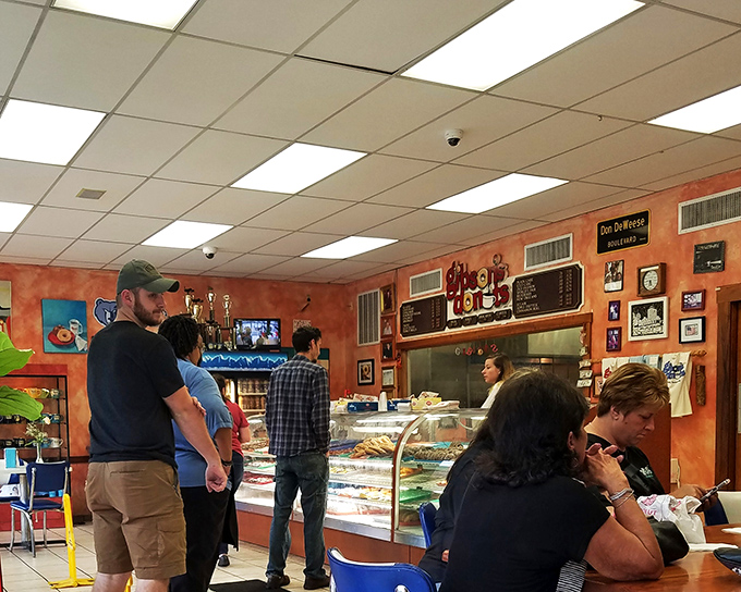 The lineup of donut pilgrims awaits their turn, each face bearing that unmistakable look of anticipation that only fresh pastries can inspire.