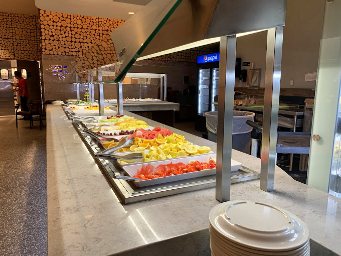 A rainbow of fresh fruit beckons from the buffet line, offering either a virtuous beginning or the illusion of balance after your third plate of sesame chicken.