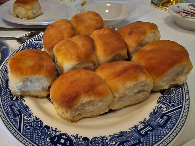 Biscuits so perfectly golden they belong in Fort Knox, ready to be slathered with butter that melts faster than your diet resolutions.