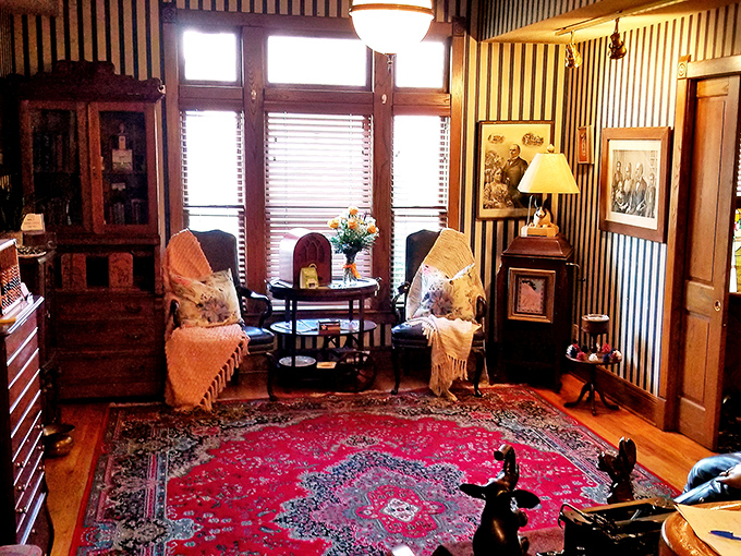 A sitting area that feels like the sophisticated living room you wish you had. Striped wallpaper and antique furniture create the perfect pre-dinner conversation spot.
