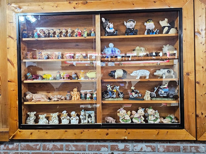 An impressive collection of pig figurines that says, "We're serious about pork, and we have the ceramic army to prove it."