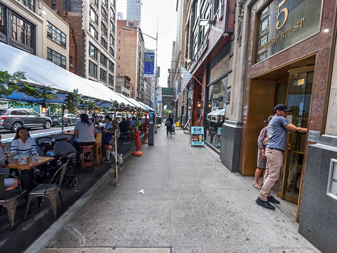 Even New York sidewalks get a touch of European charm when the weather permits. Urban al fresco dining at its finest.